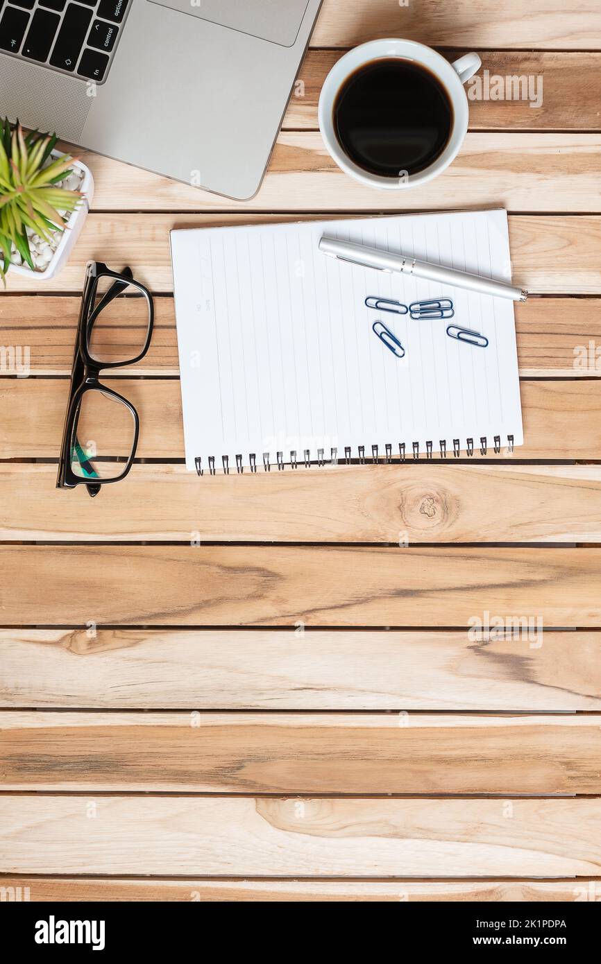 Top view Office desk with blank notebook, pen, paper clips, computer ...