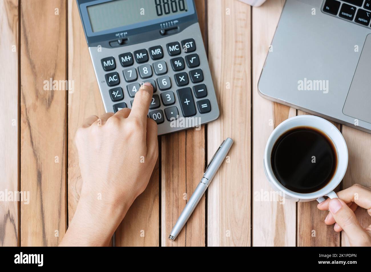 Top view Business woman hand holding coffee cup and calculating with ...
