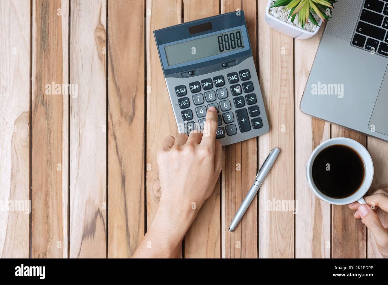 Top view Business woman hand holding coffee cup and calculating with ...