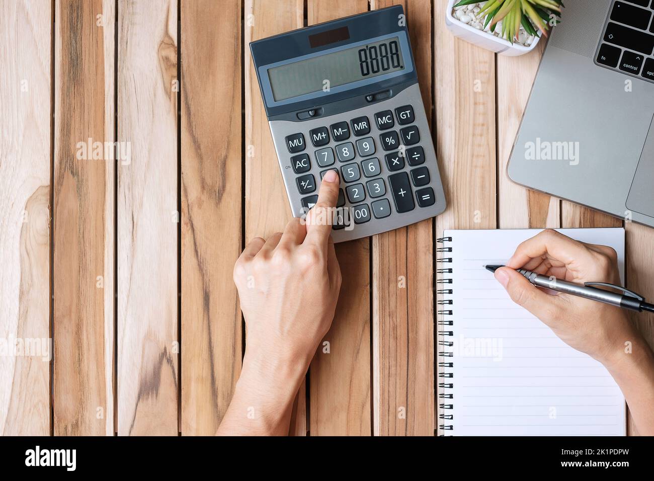 Top view Businesswoman hand writing and calculating with calculator ...