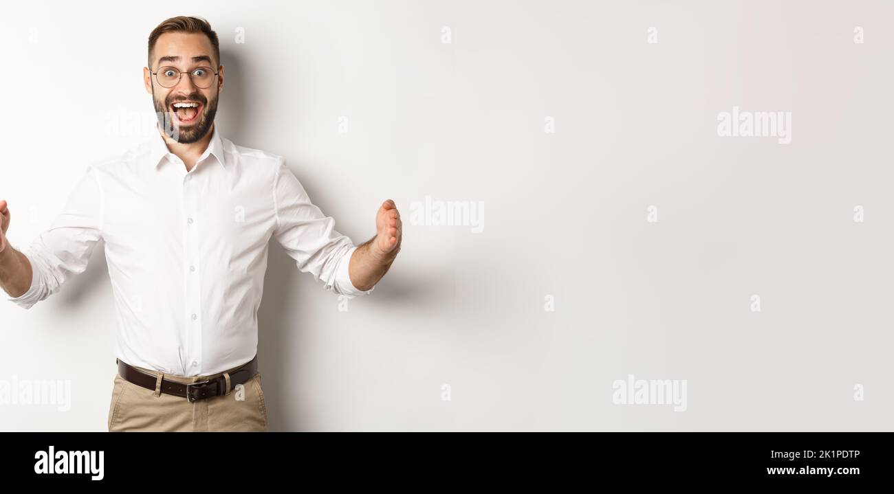 Amazed businessman showing big object, describe something large and ...