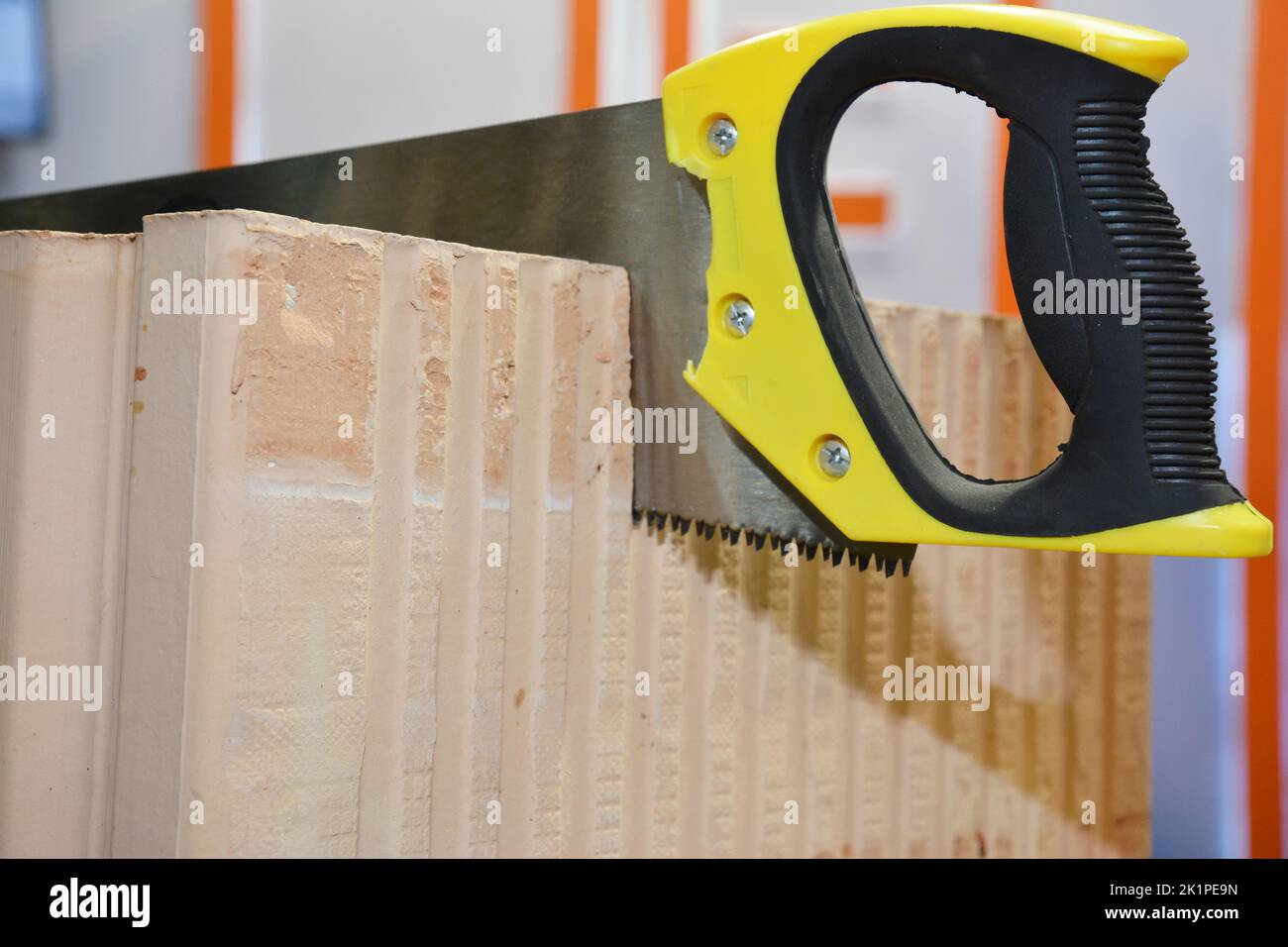 Cutting porous ceramic block with hand saw Stock Photo - Alamy
