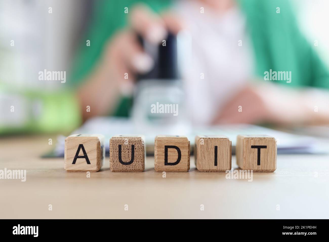 Business woman examines financial documents with reports and conducts ...