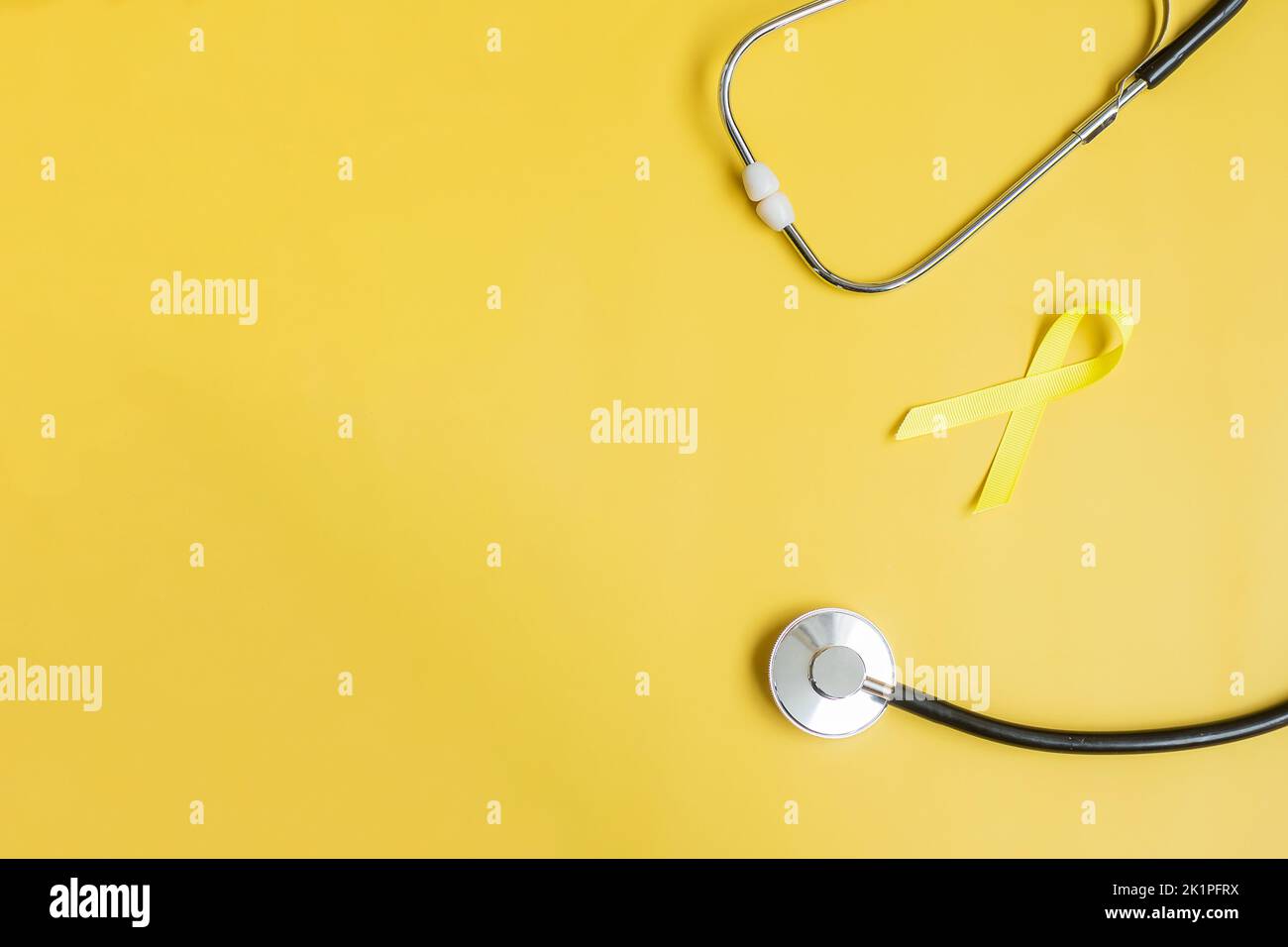 Yellow Ribbon and Stethoscope on yellow background for supporting ...