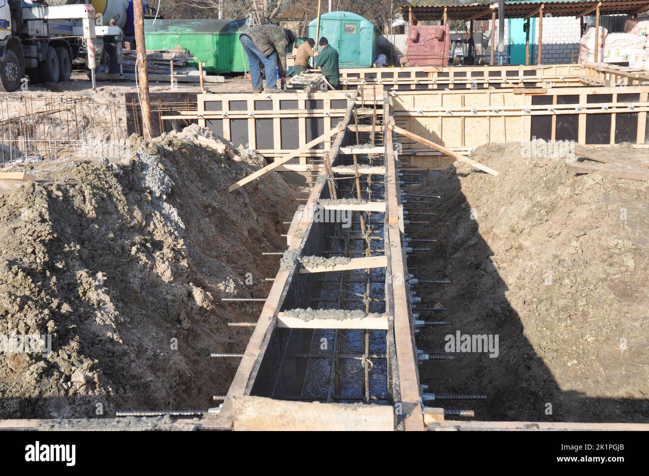 Builder contractors installing iron and wooden framework to build a ...