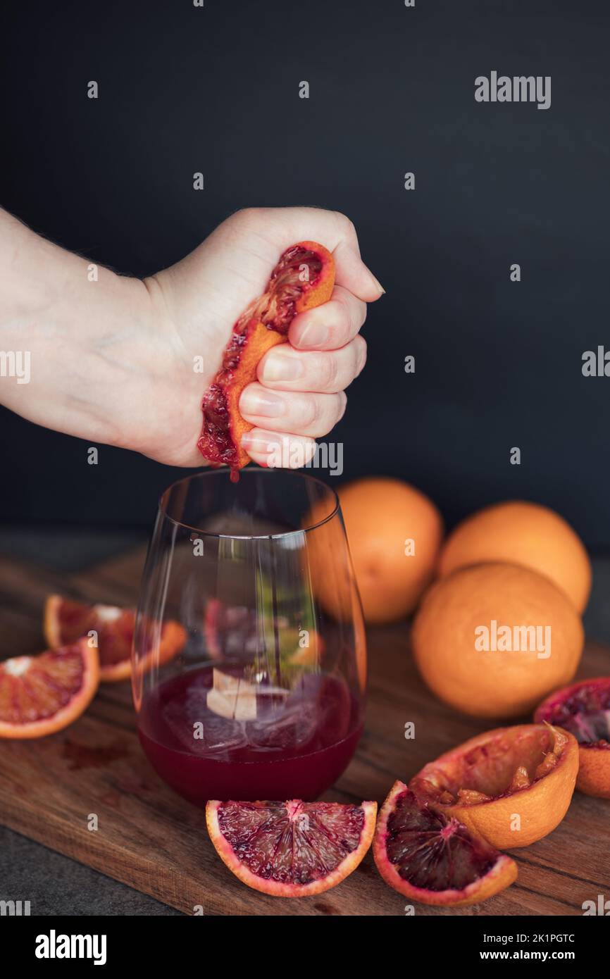 Blood Orange Being Squeezed into Glass Fresh Blood Orange Juice Stock ...