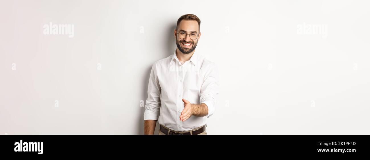Confident businessman extending hand for handshake, greeting business ...