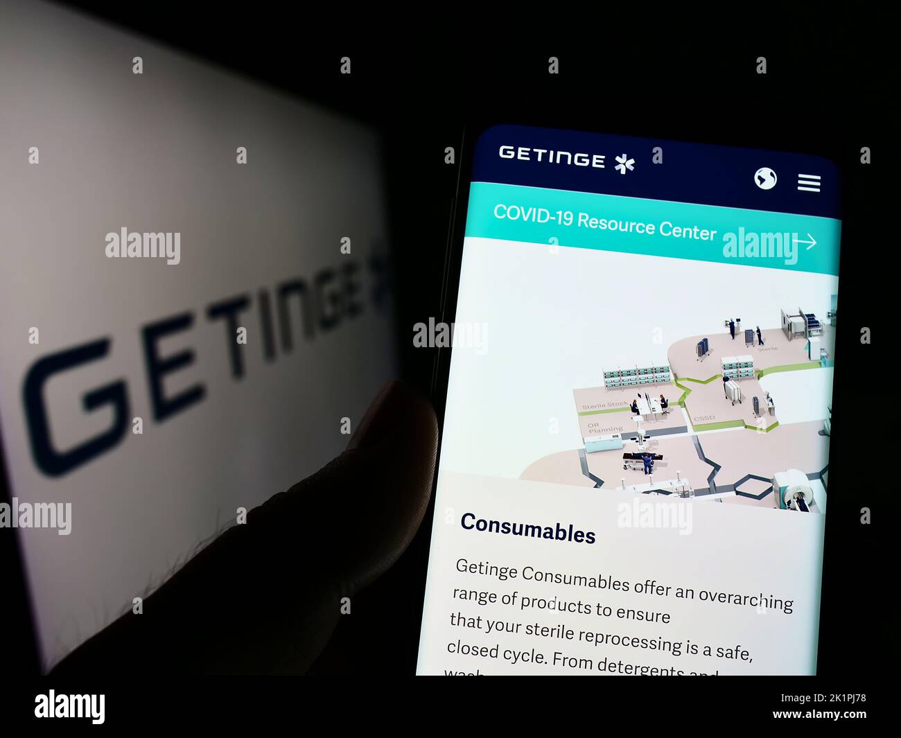 Person holding cellphone with webpage of Swedish medical technology ...