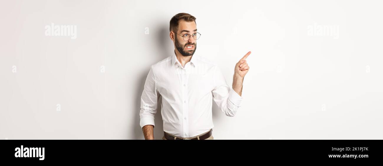 Young bearded guy seeing something disturbing, cringe while pointing ...