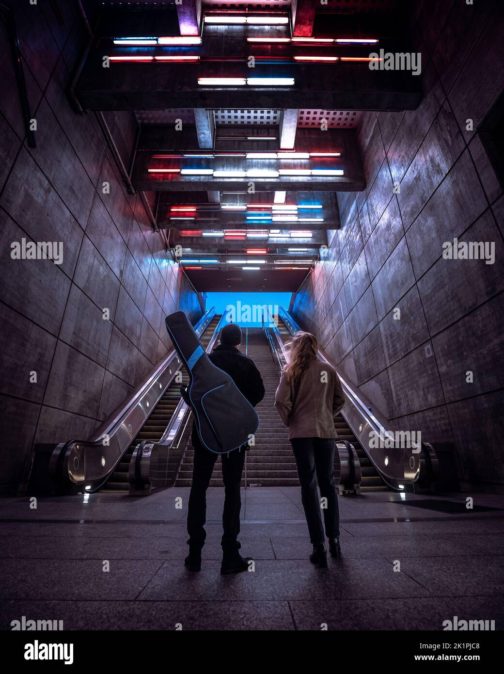 A mesmerizing vertical shot of a street musician with a friend near ...