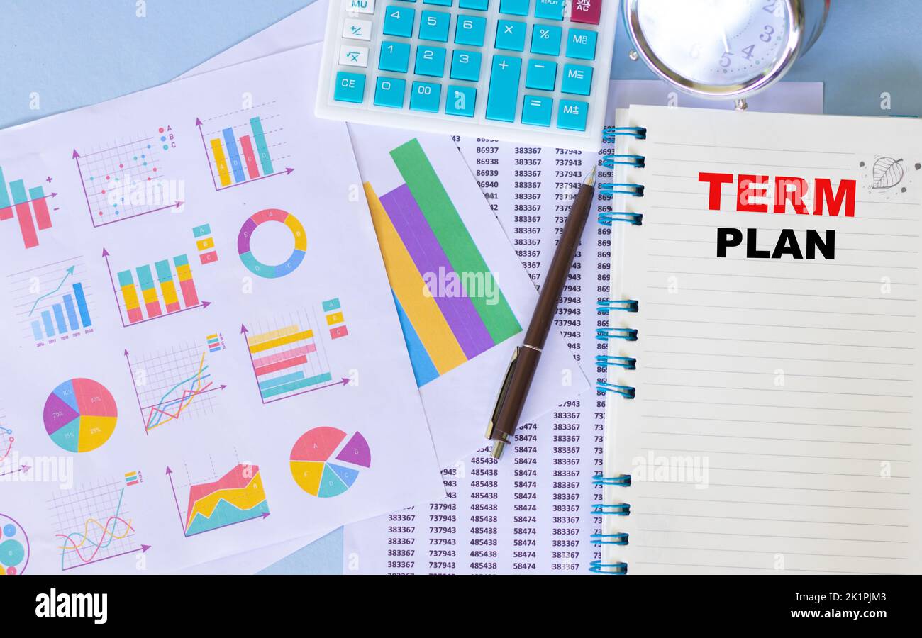 A top view of an office desk table with analysis chart papers and "term ...