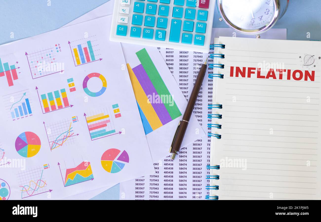 A top view of an office desk table with analysis chart papers and ...