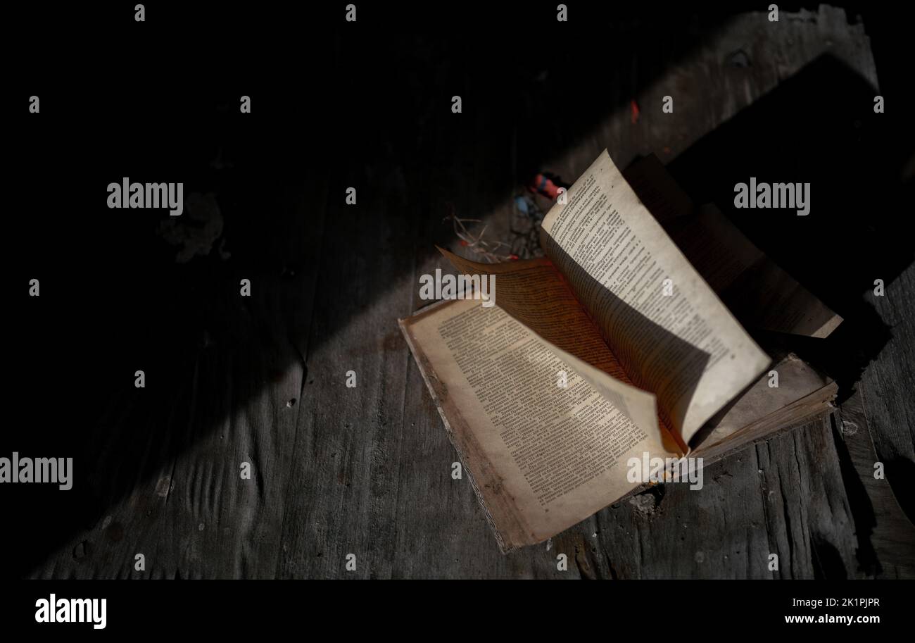 A top view of an old, damaged book on a dark background Stock Photo - Alamy
