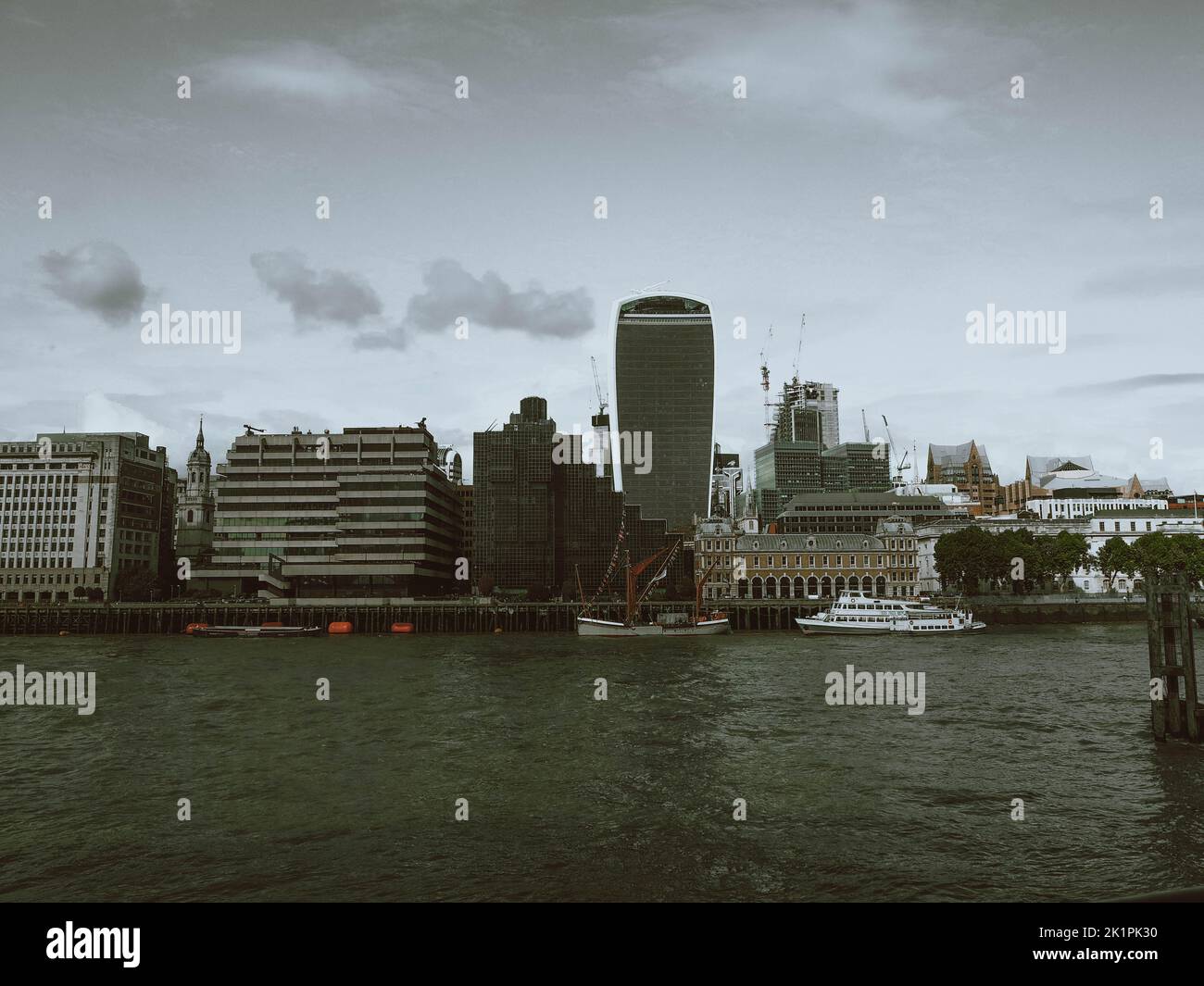 A dark view of the modern buildings at the waterfront at Thames river ...
