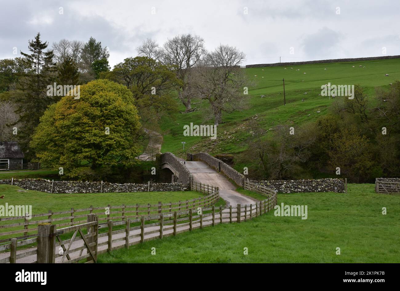 Scenic curved and winding roadway with a bridge through rural farmland ...