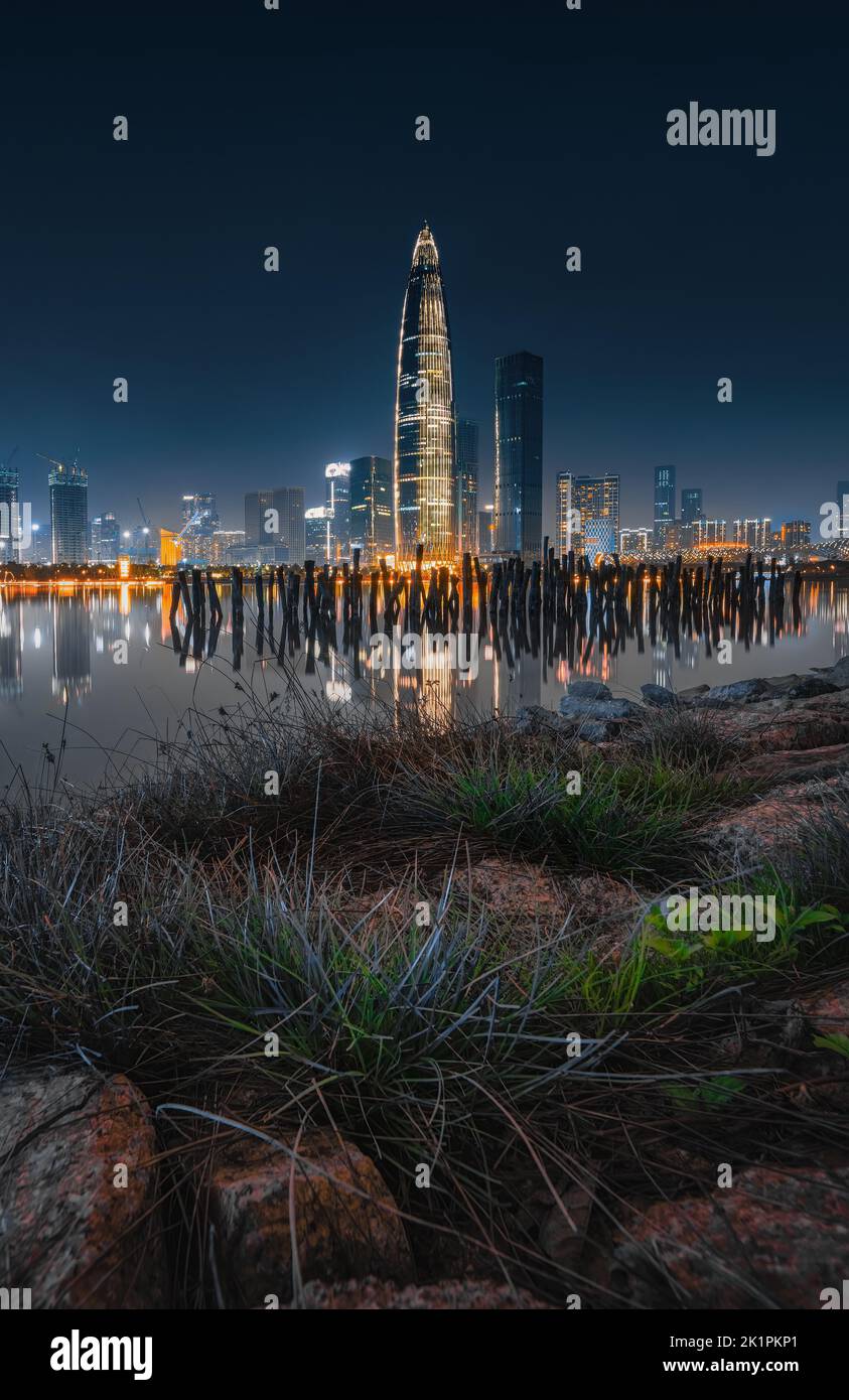 A vertical shot of the China Huarun Building at night with a view of a ...