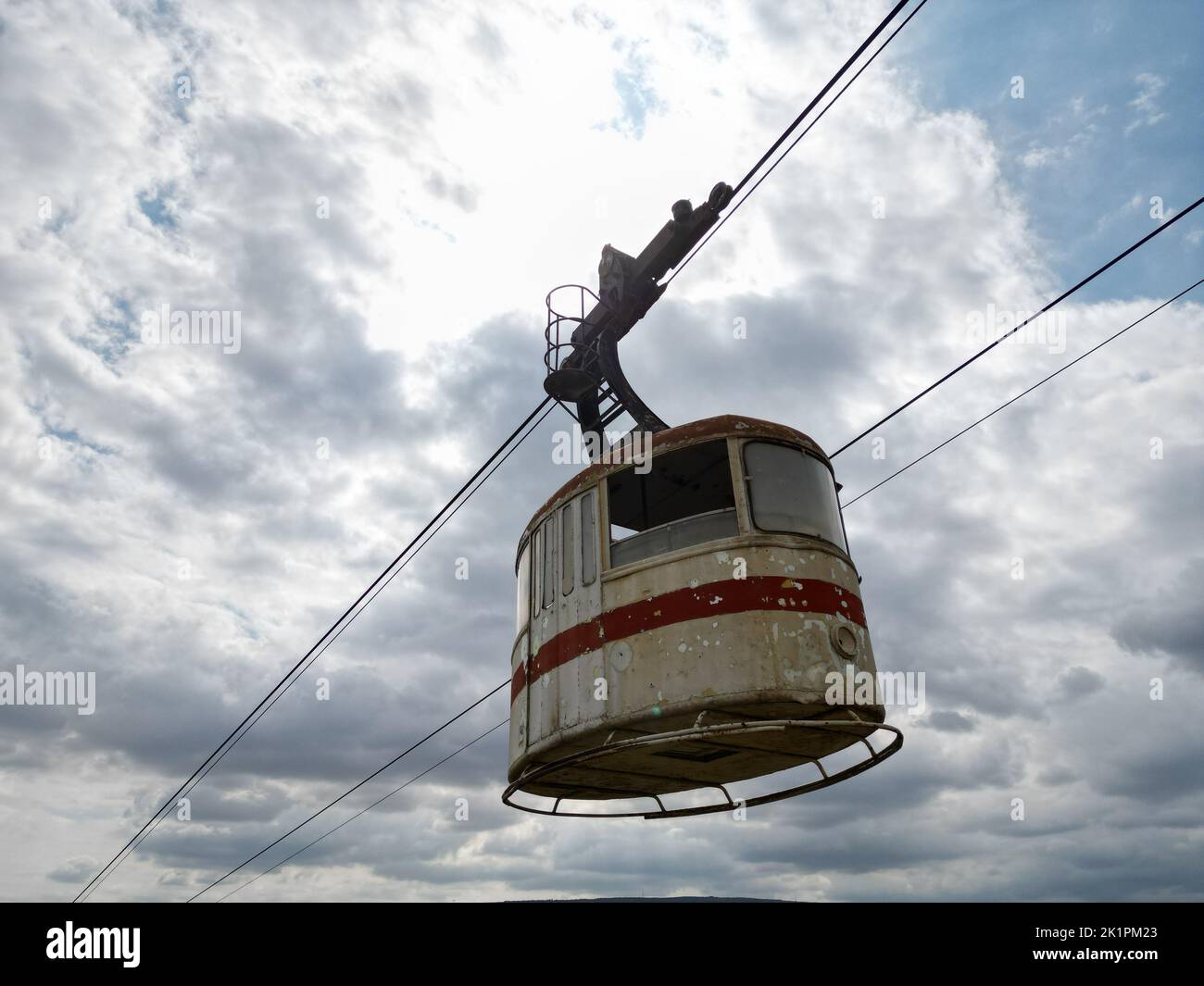 A closeup of an abandoned cable car against a cloudy sky at Samgori ...