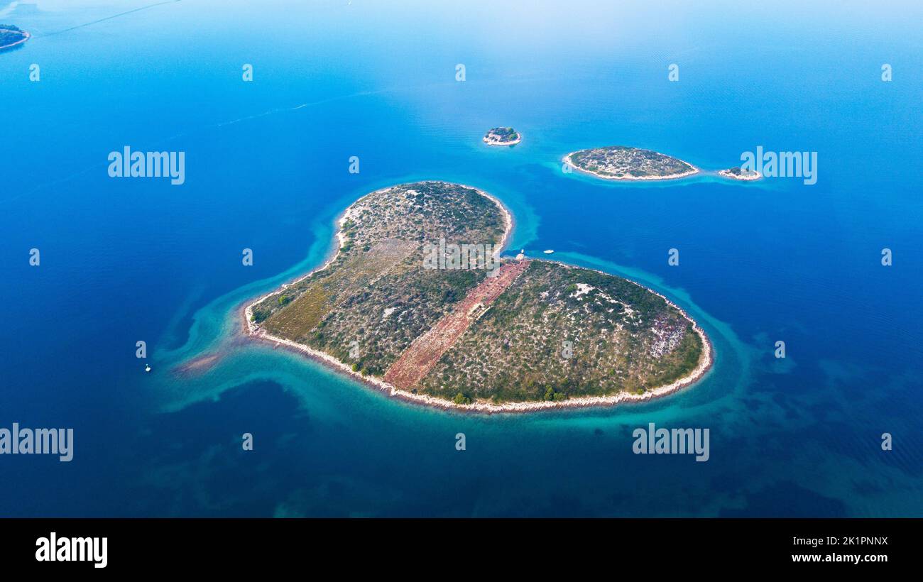 An aerial shot of the heart-shaped Galesnjak island surrounded by ...