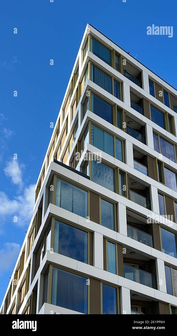 A vertical shot of a modern building facade with glass windows Stock ...