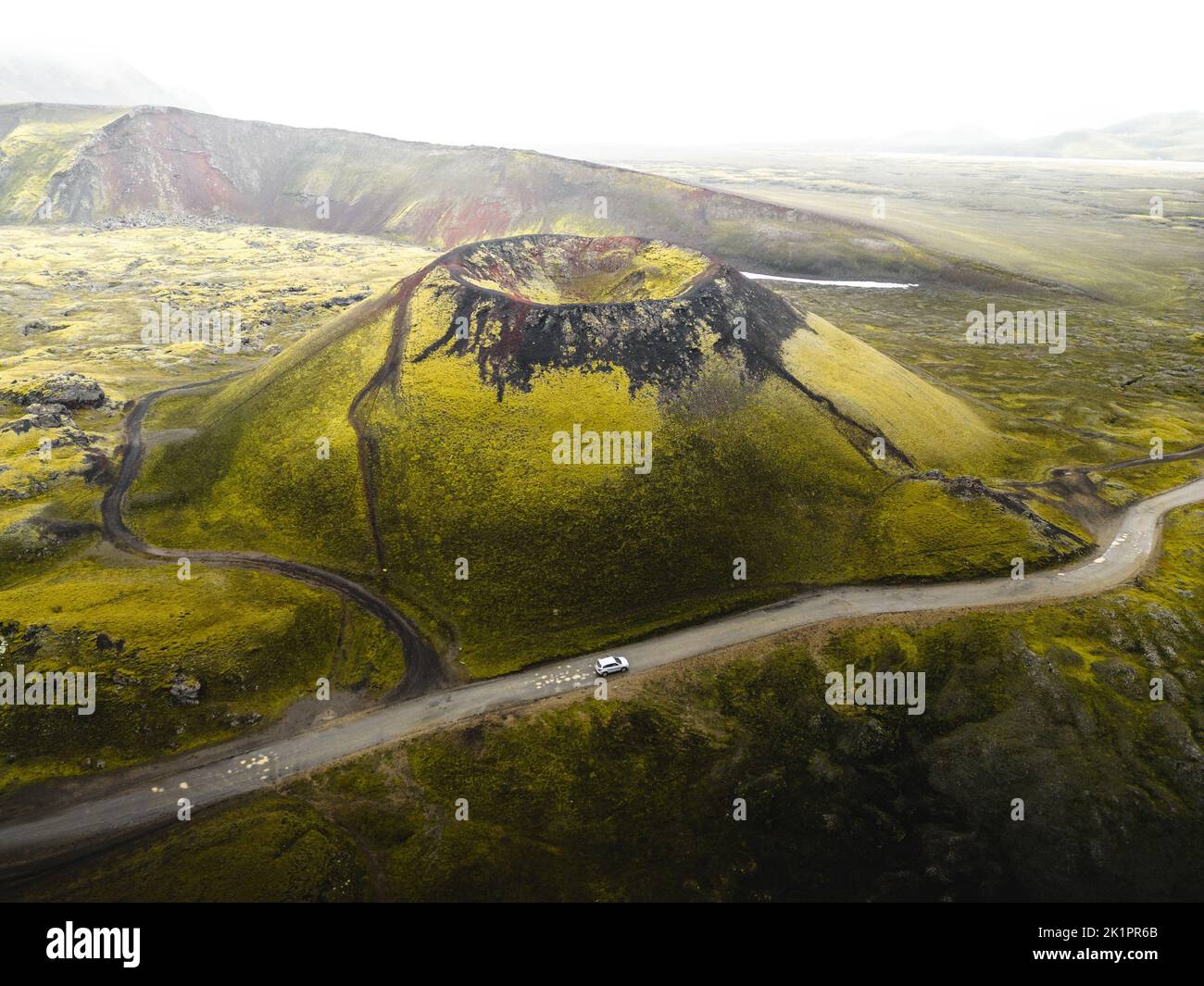An aerial view of Laki volcano surrounded by greenery hills with road ...