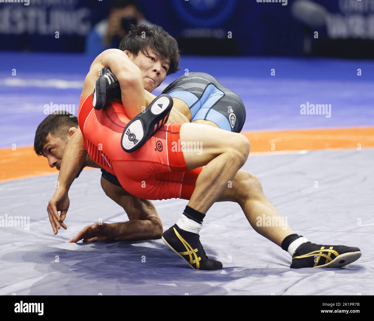 Japan's Rei Higuchi (red) competes en route to winning the men's 61 ...