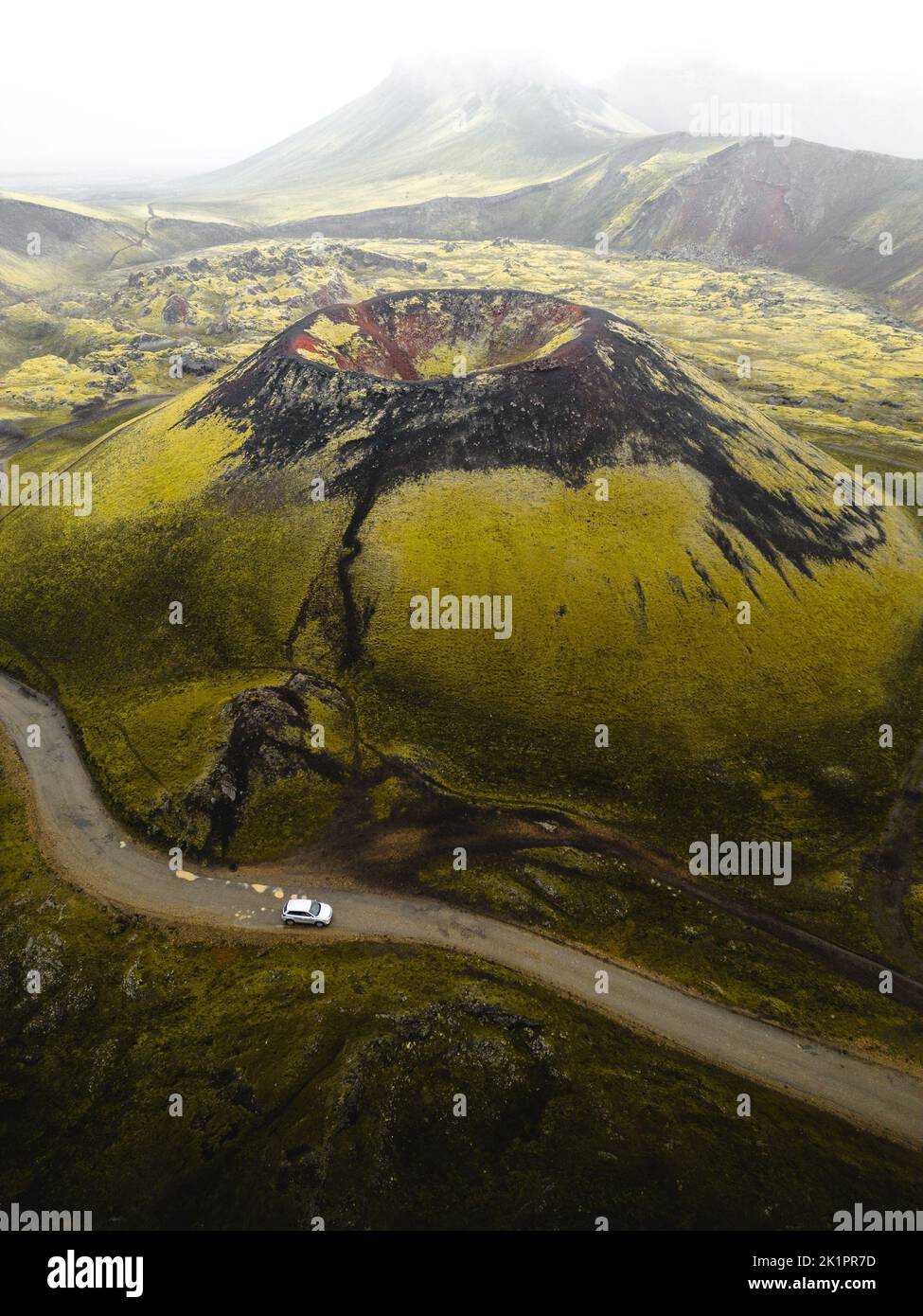 An aerial view of Laki volcano surrounded by greenery hills with road ...