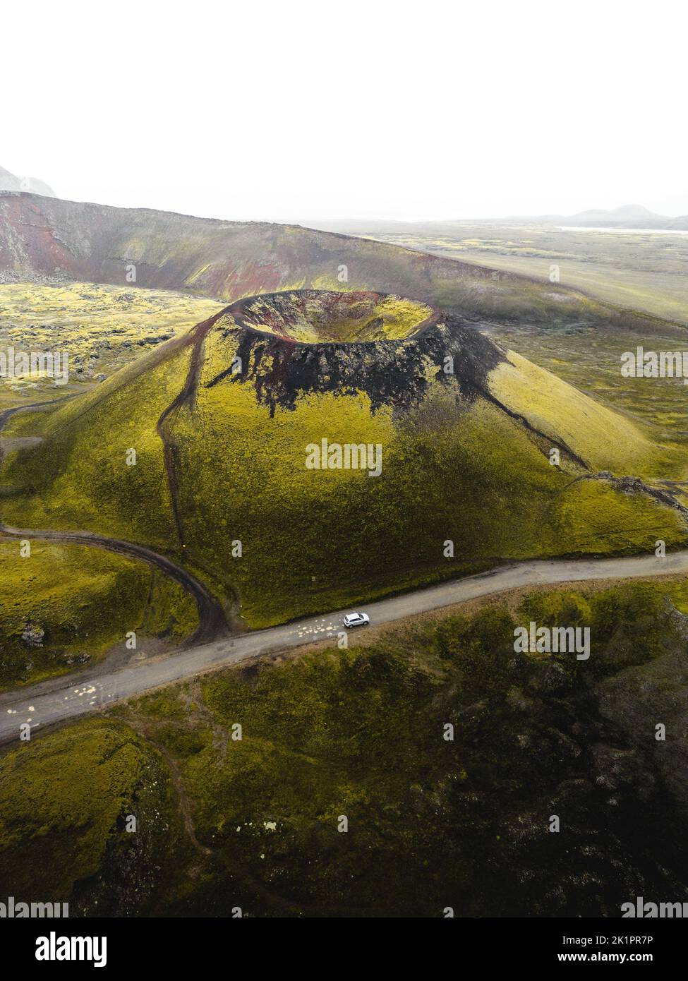 An aerial view of Laki volcano surrounded by greenery hills with road ...