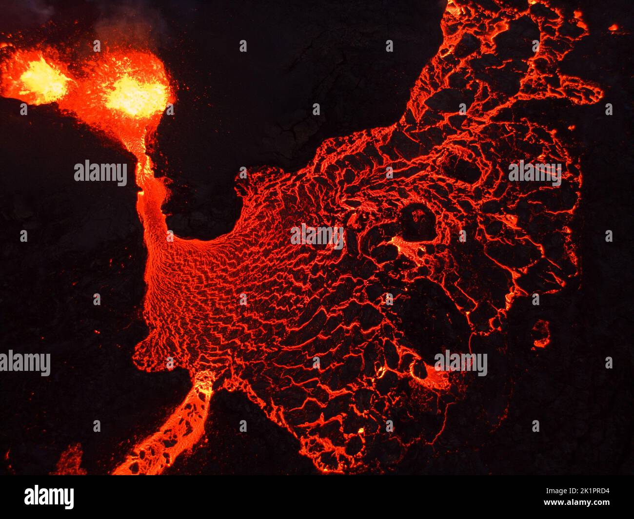 A beautiful shot of lava flowing from a volcano at night in Iceland ...