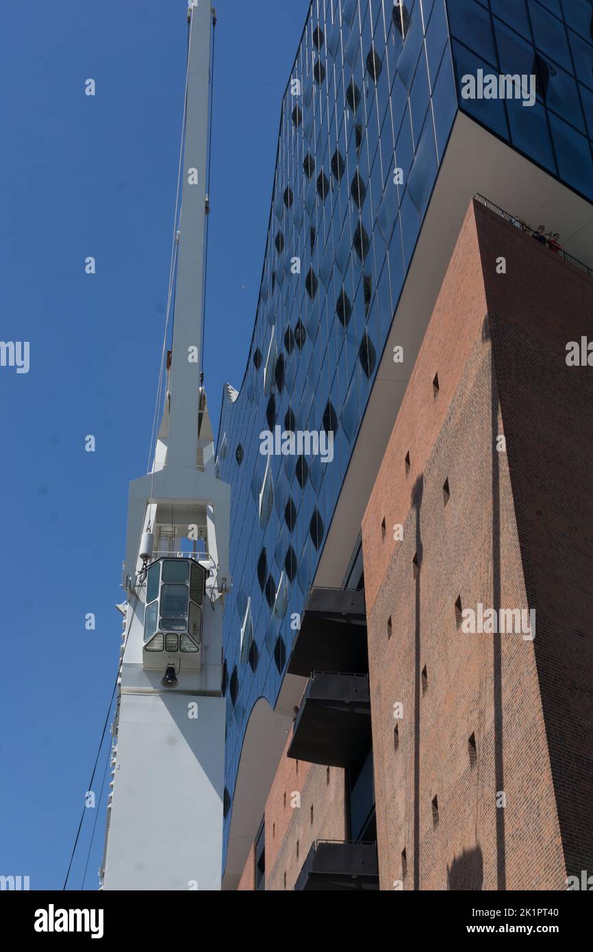 A low-angle shot of a modern glass building with wavy window shapes in ...