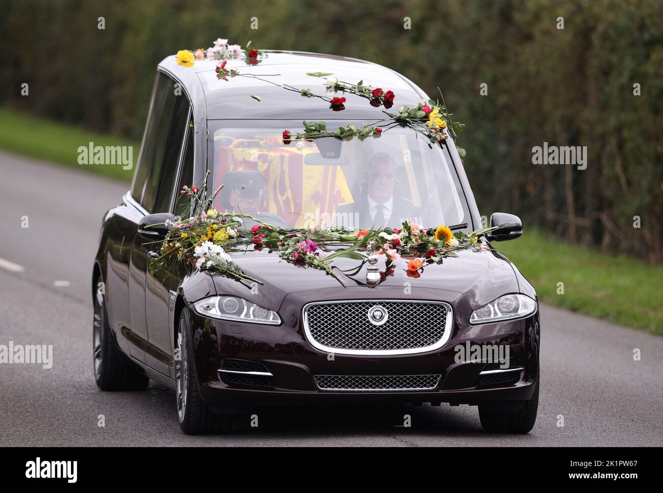 The State Hearse carrying the coffin of Queen Elizabeth, draped in the Royal Standard with the ...