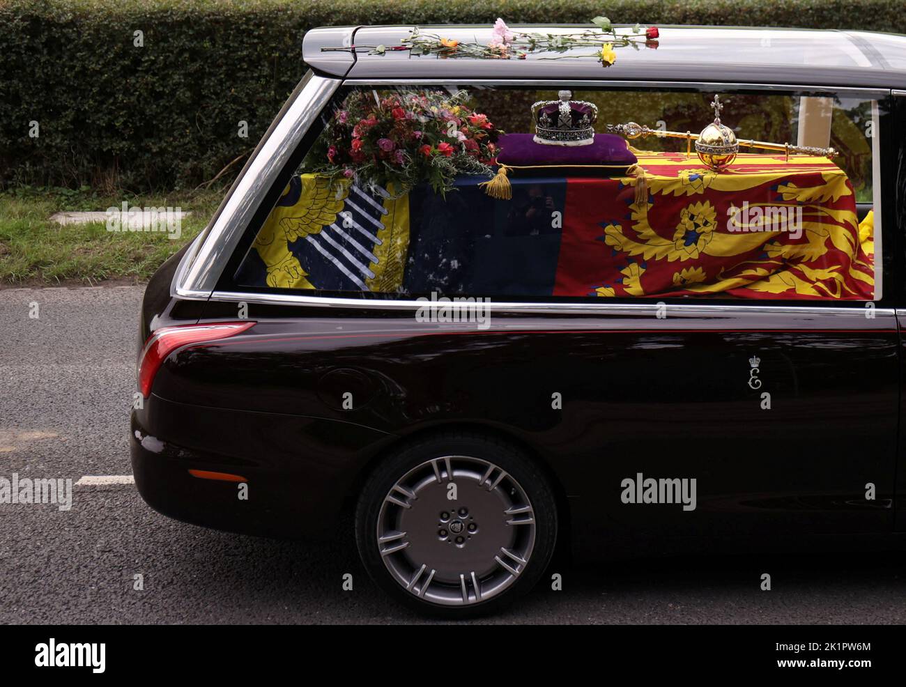 The State Hearse carrying the coffin of Queen Elizabeth, draped in the Royal Standard with the ...