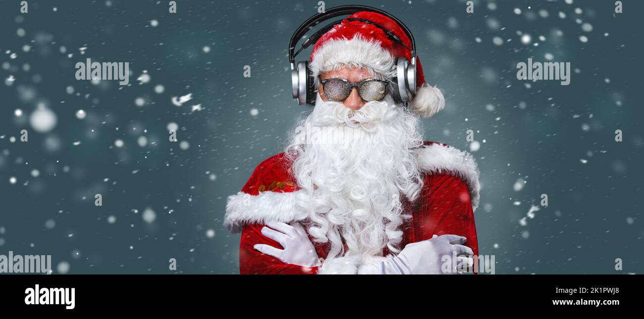 Cool Santa Claus is listening music in headphones Stock Photo - Alamy
