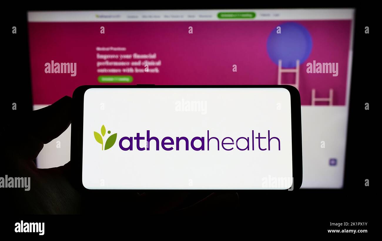 Person holding mobile phone with logo of American healthcare company ...