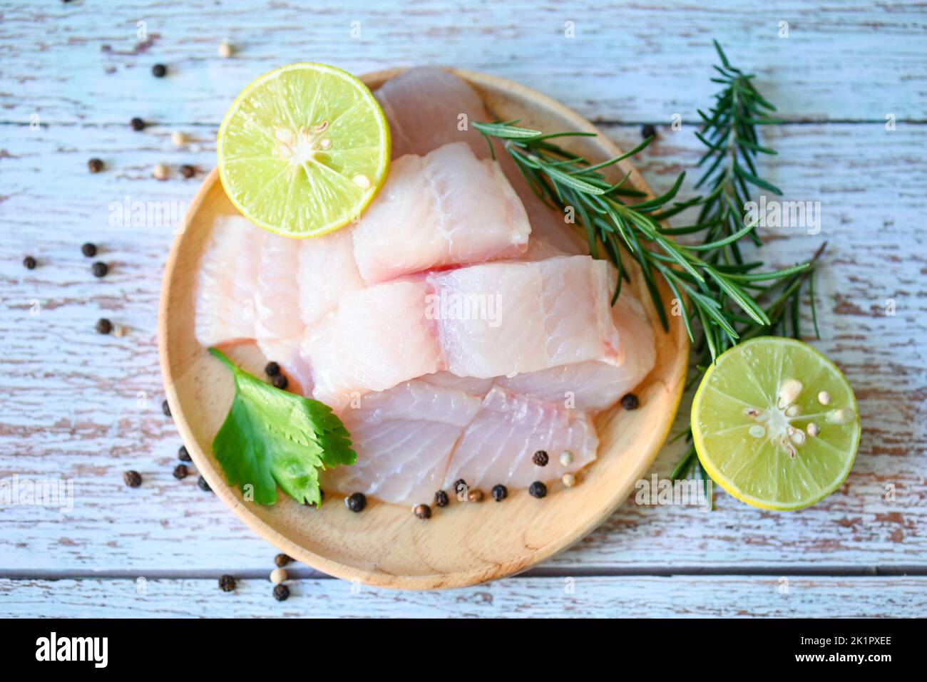 fresh raw pangasius fish fillet with herb and spices black pepper lemon ...