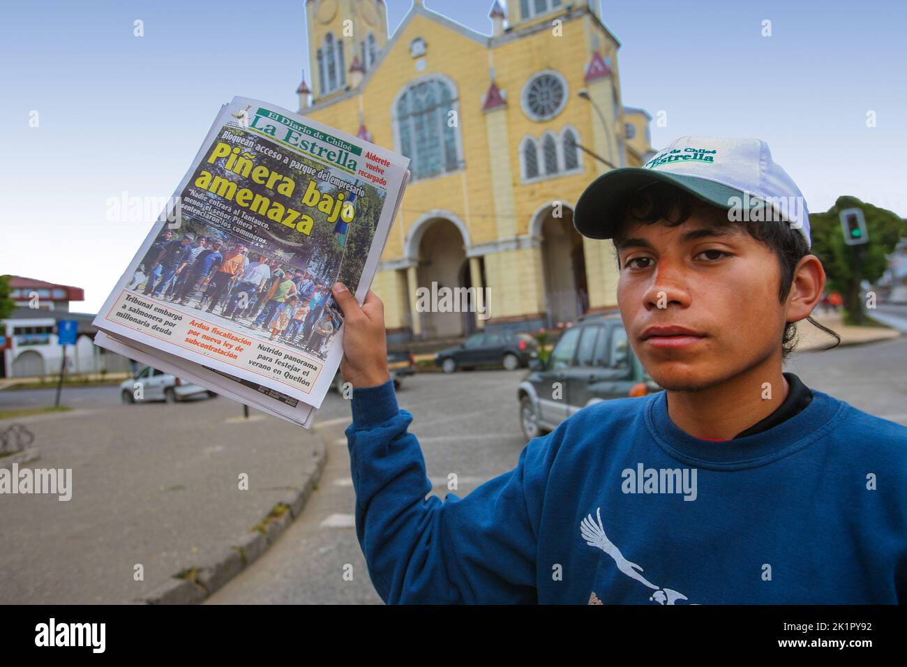 Chile, Chiloe island -Boy is selling the daily newspaper La Estrella in ...