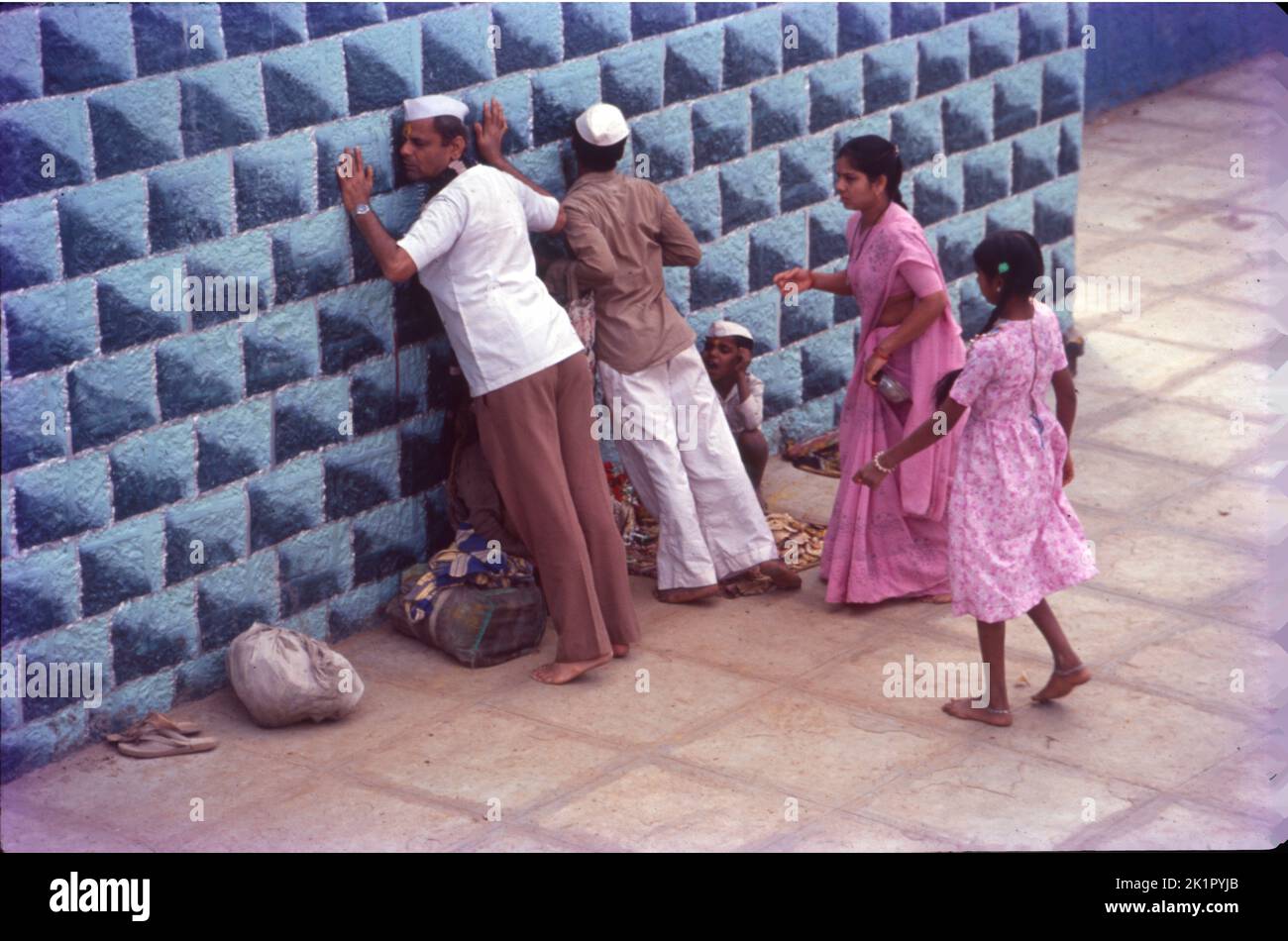 Pilgrims touching outer wall of the temple hi-res stock photography and ...