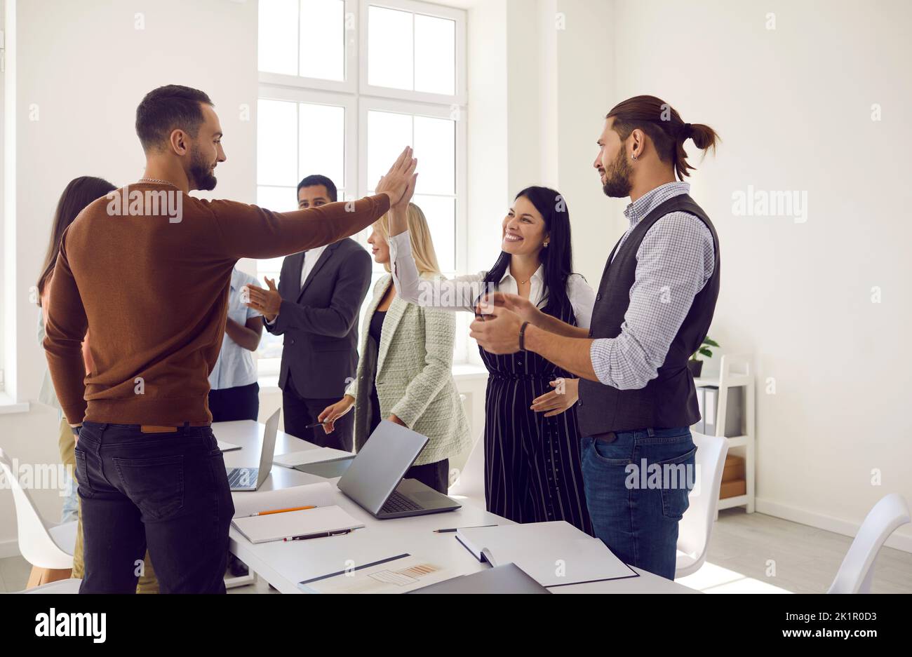 Smiling diverse employees celebrate team success Stock Photo - Alamy