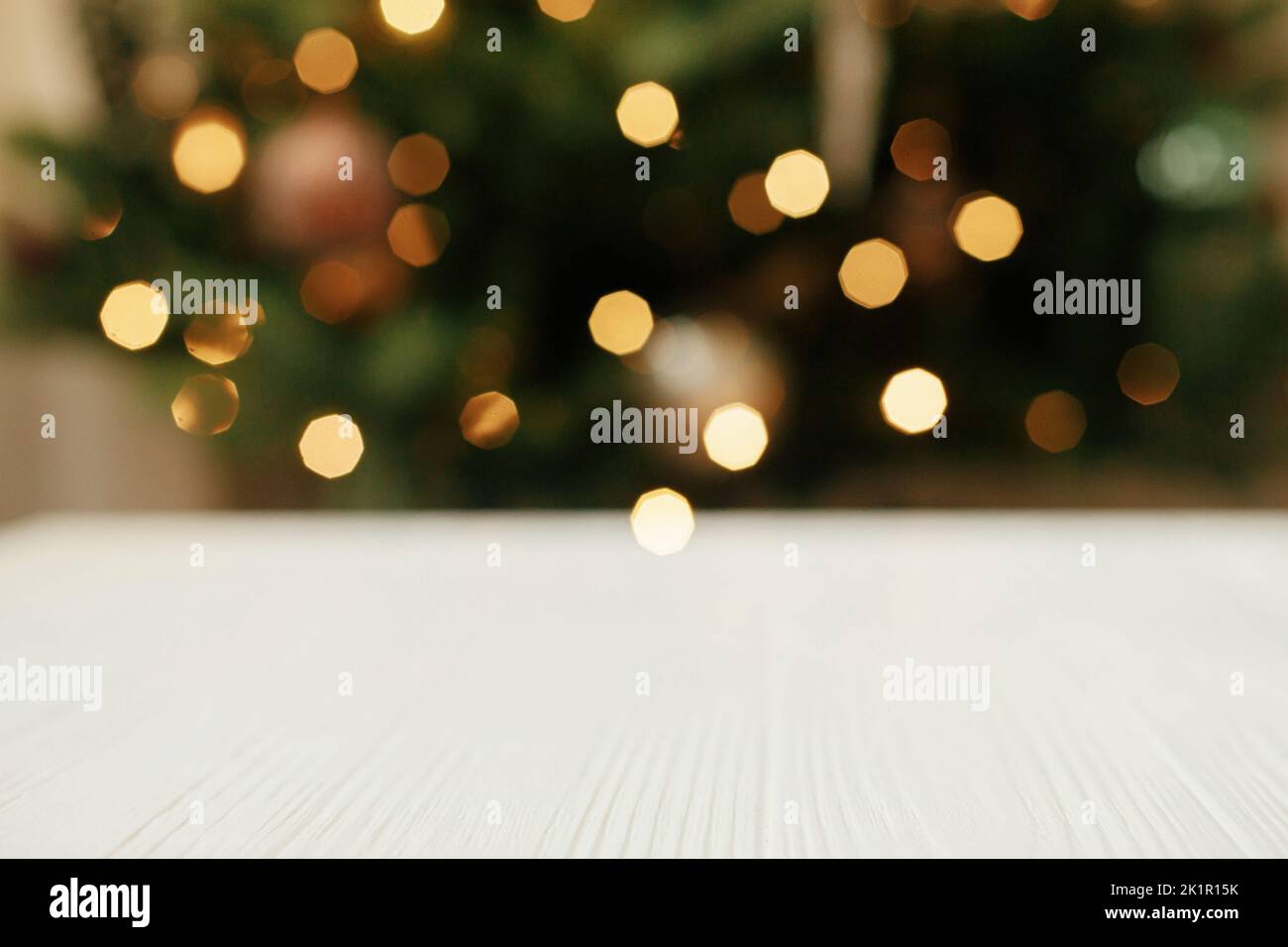 Wooden table close up on background of christmas tree with golden ...