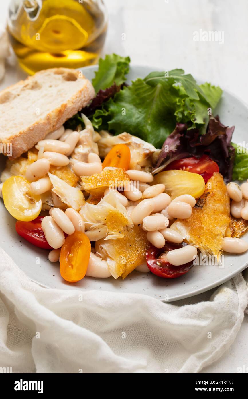 fried cod fish with white beans on the plate Stock Photo - Alamy