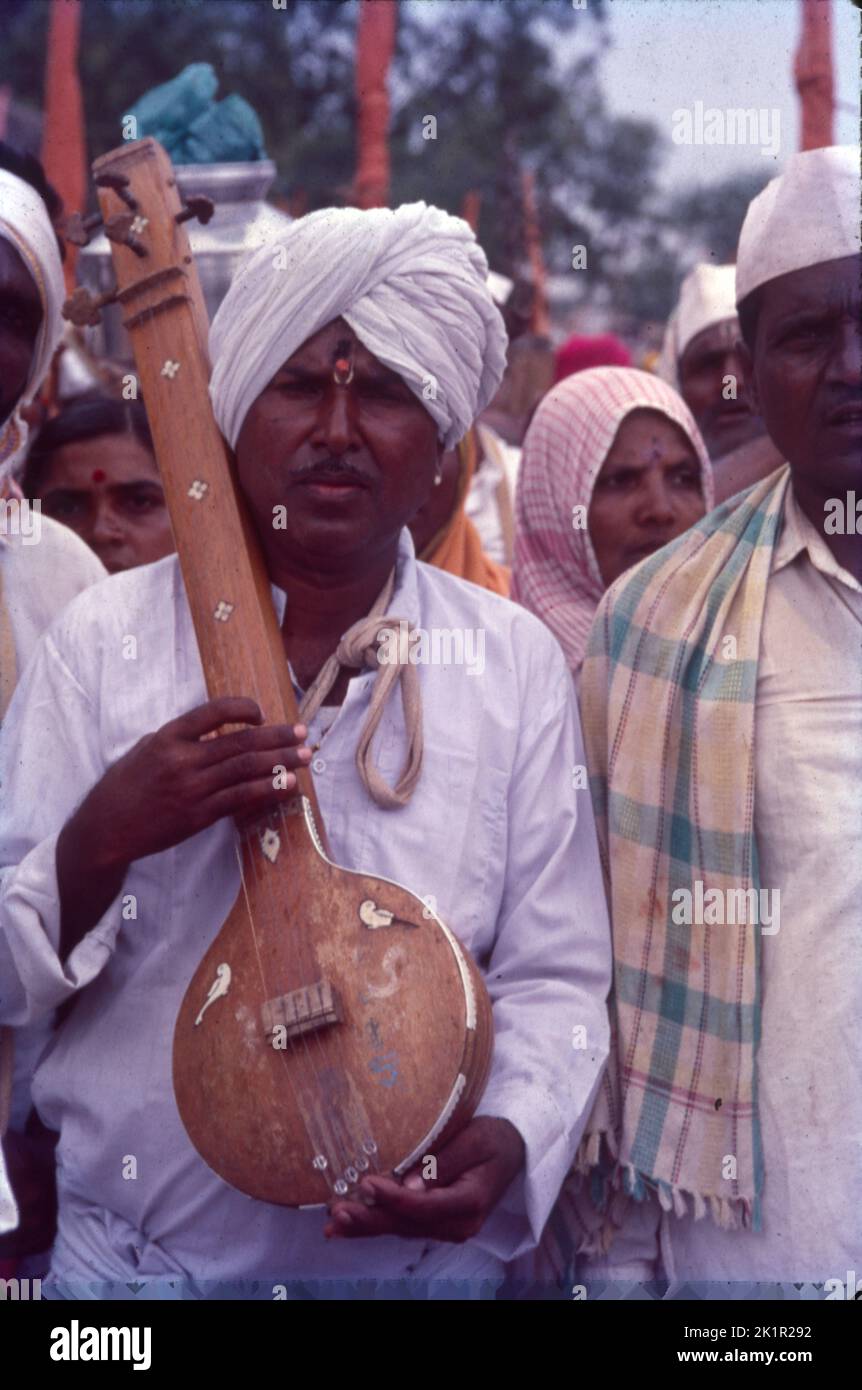 Dindi Festival, Devotee Playing Miniature Sitar Stock Photo - Alamy