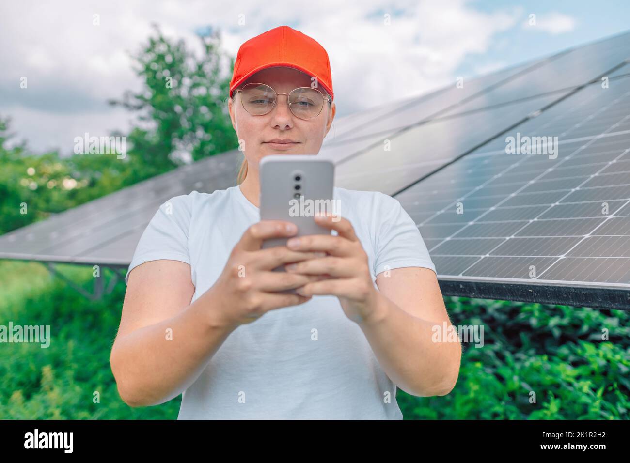 Person checking the solar power generation of solar panels domestic ...