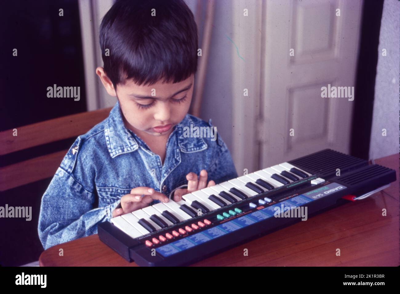Child Playing Music on Electric Key Board Stock Photo - Alamy