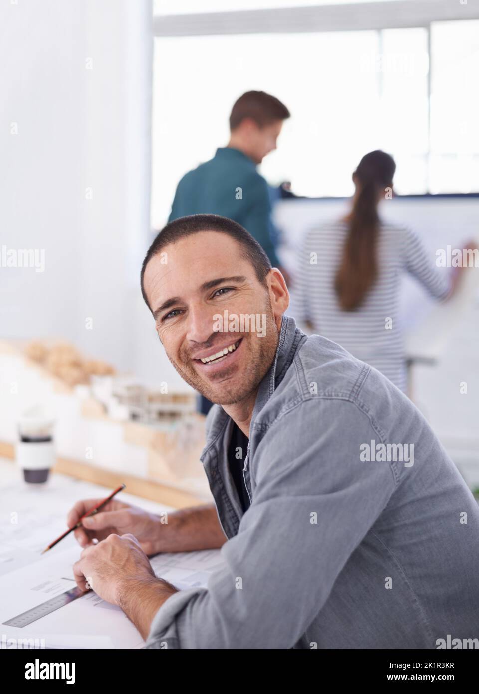 He loves the creative aspect of his job. Portrait of a handsome ...