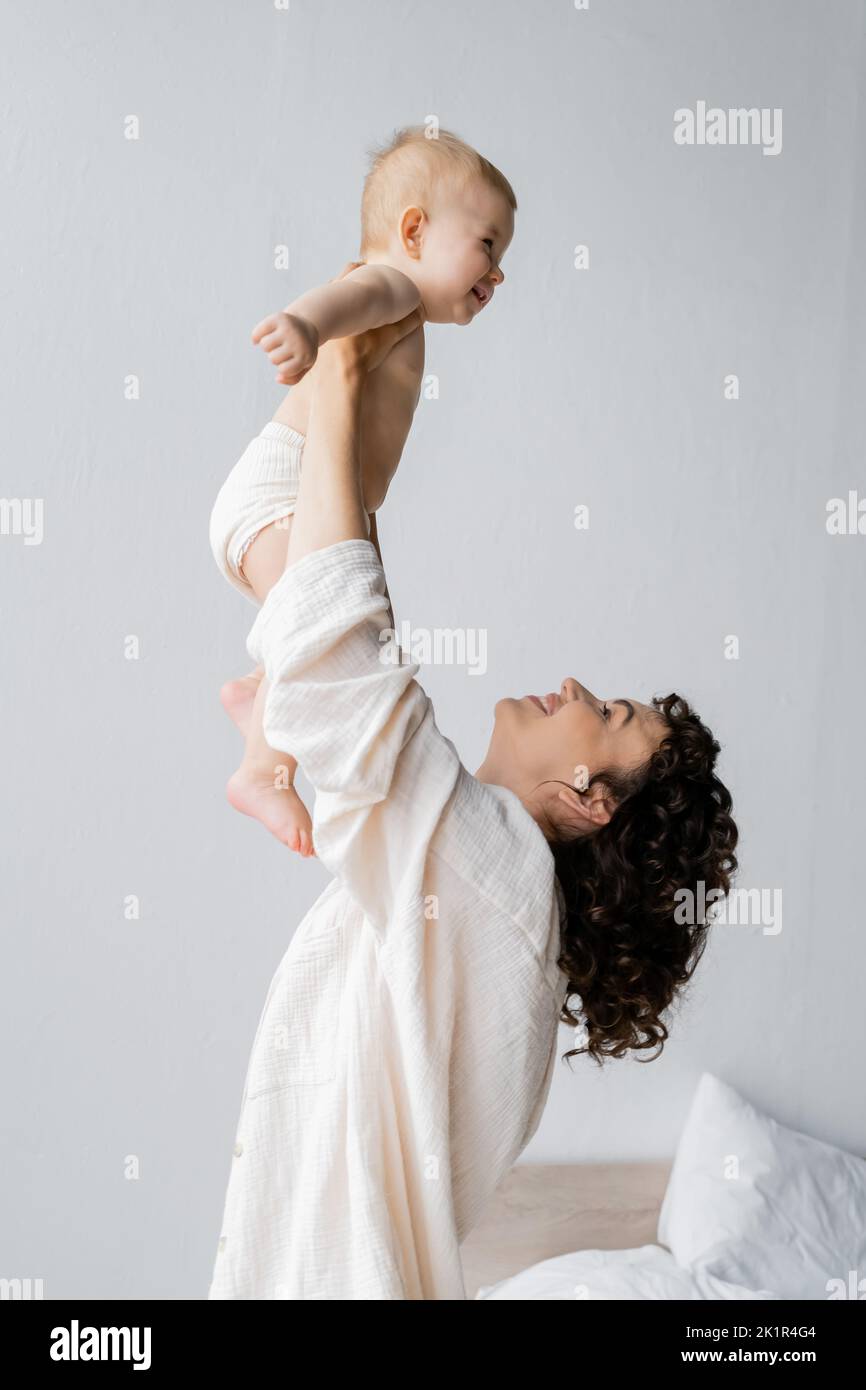Lifting baby hi-res stock photography and images - Alamy