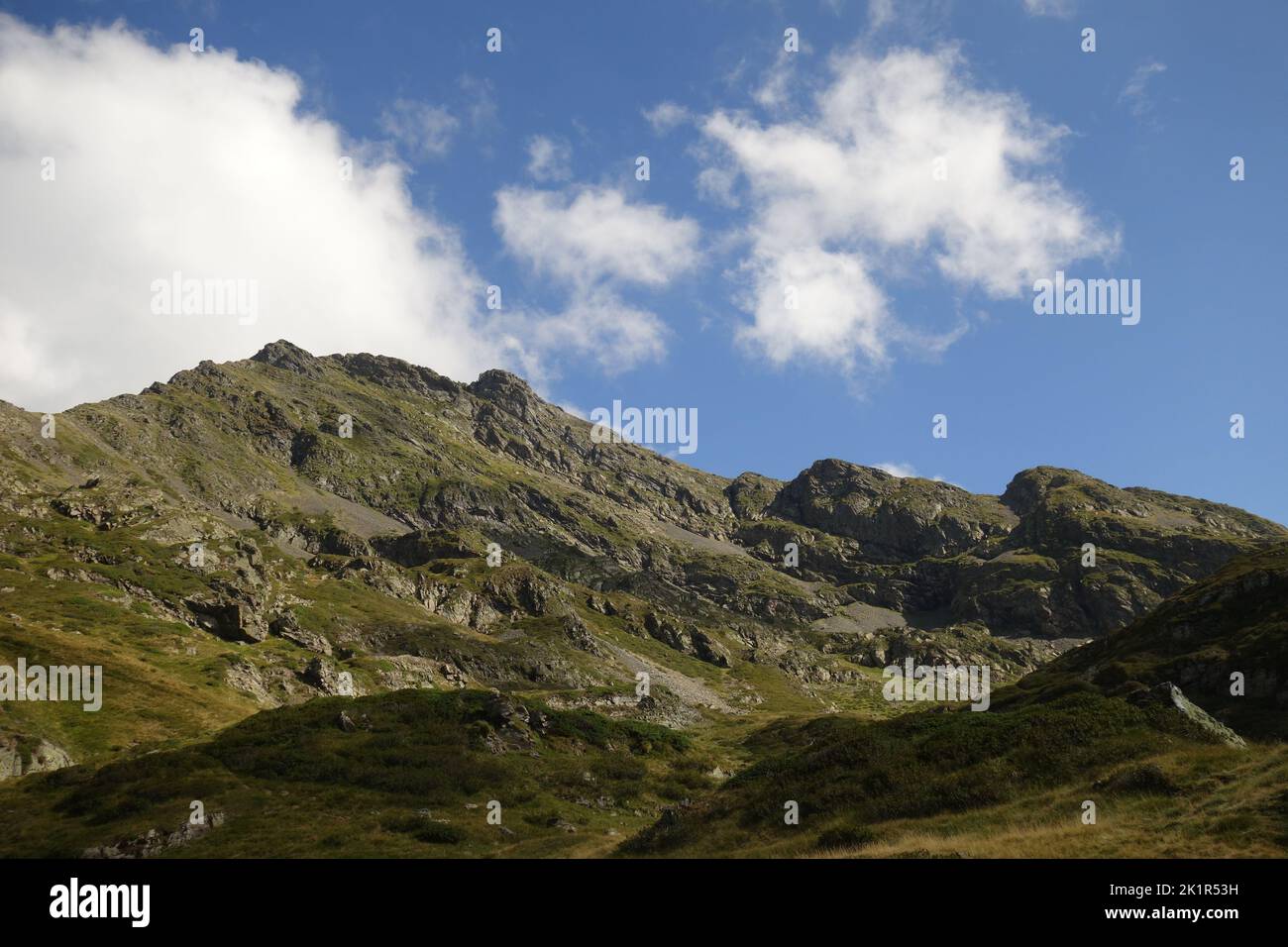 Sky view behind a mountain ridge in the French Pyrenees. Sunny day with ...