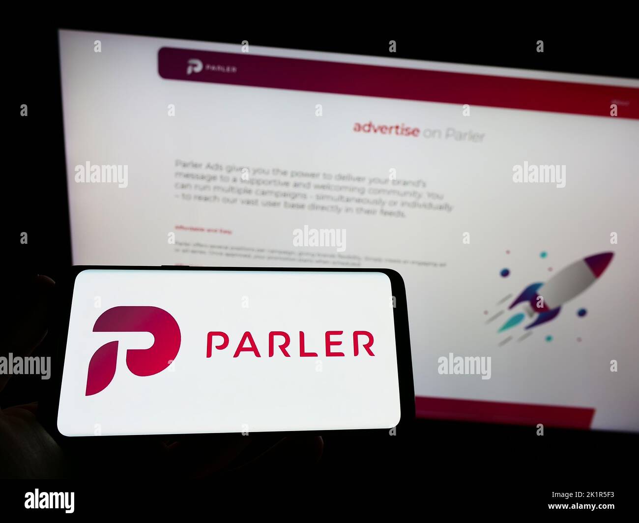 Person holding smartphone with logo of US social networking company ...