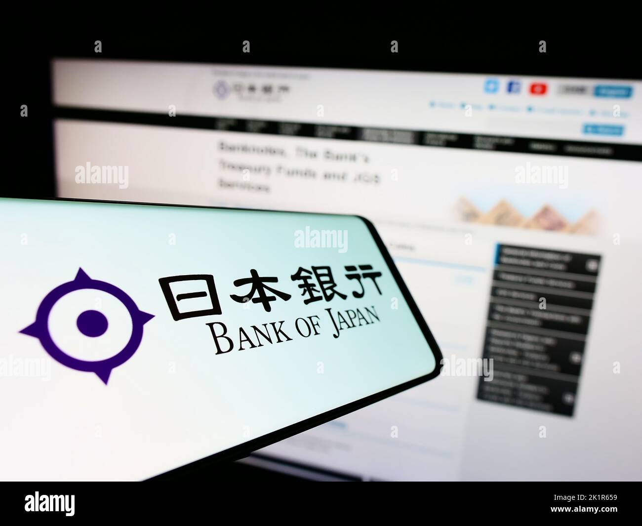 Cellphone with logo of financial institution Bank of Japan (BOJ) on ...