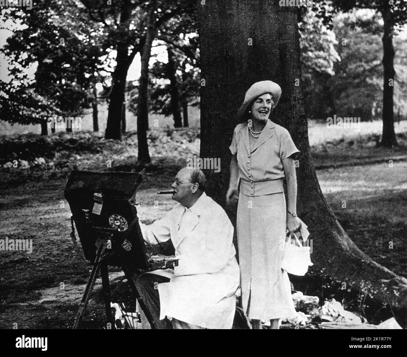 Winston Churchill painting in the grounds of Chartwell with his wife ...