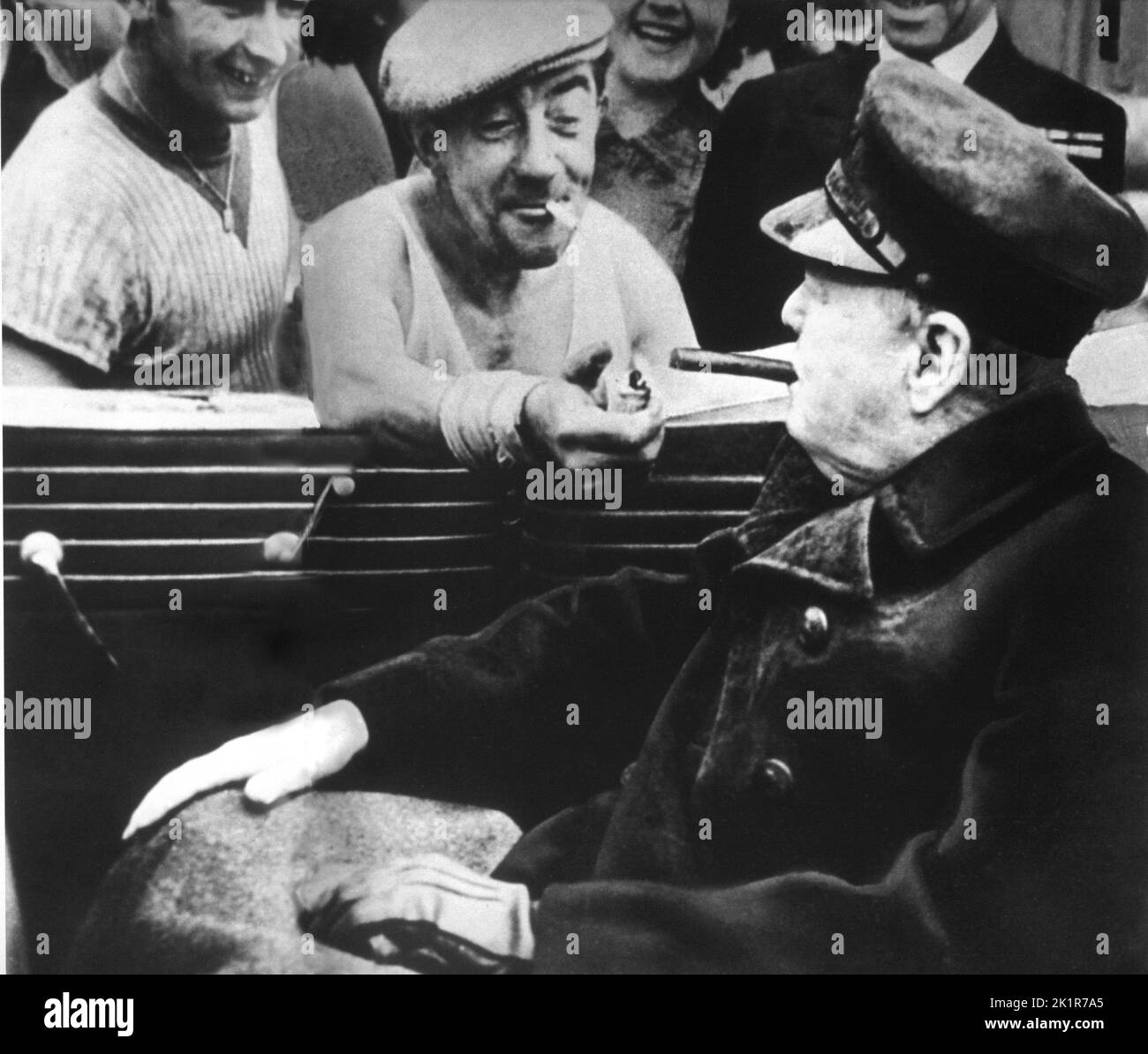 Winston Churchill accepting a light from a dockworker while inspecting ...