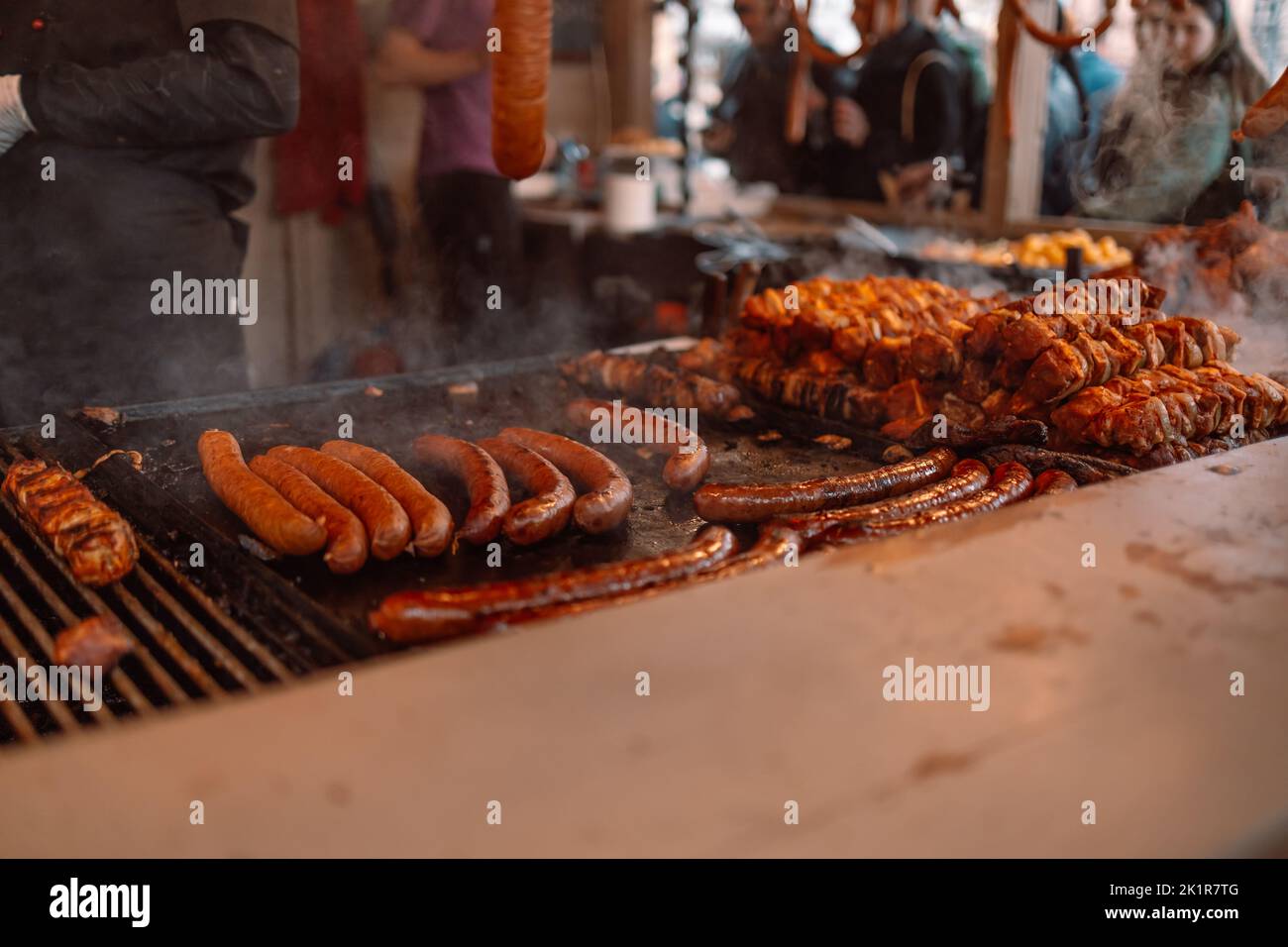 Fried baked sausages, hot dog on street food outdoor market stall in ...